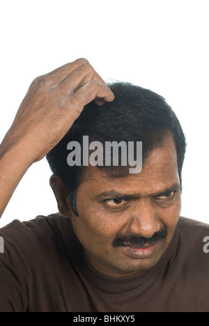 Confused and annoyed man scratching head, arguing and complaining ...