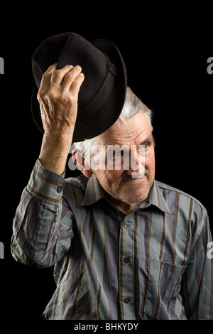 Old man saluting with his hat, isolated on black Stock Photo - Alamy