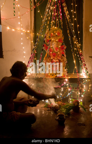 A Brahmin blesses a statue of Ganesh, the elephant god of the Hindu ...