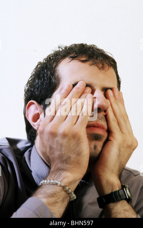 young man straining eyes after removing glasses, are they correct ...