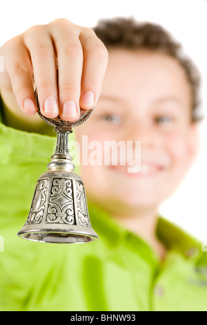Cheerful boy ringing hand bell in front of him, blue background Stock ...