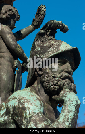Close-up of a classical statue of a bearded man in robes on a historic ...