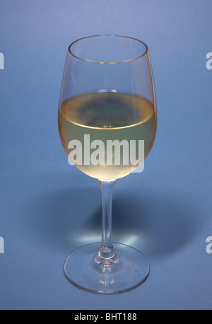 White wine in glass on room background Stock Photo - Alamy