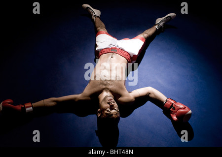 Knocked out boxer lying in boxing ring Stock Photo - Alamy
