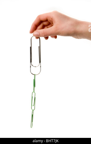 small and big paper clips on a green surface Stock Photo - Alamy