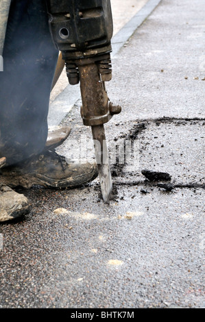workman digging road Stock Photo - Alamy