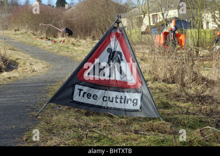 Tree cutting men at work warning signs, in the woods for walkers Stock ...