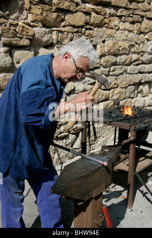 Black smith beating iron rod using hammer, Inle, Myanmar Stock Photo ...