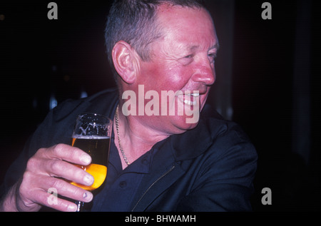 man with flushed red face from alcohol drinking lager Stock Photo - Alamy