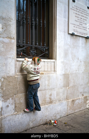 young boy climbing through a window to get into a house Stock Photo ...