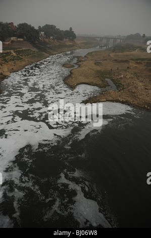 Plastic waste floating down a river causing pollution in a river in ...