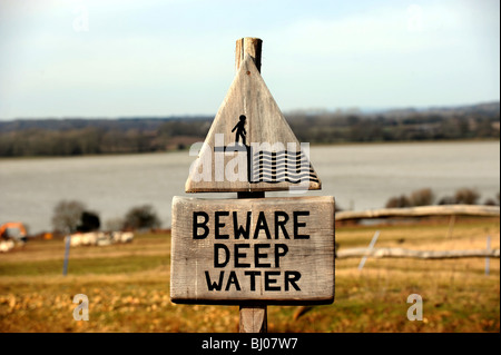 A Danger, Beware Deep Cold Water warning sign on a beach in Kent Stock ...