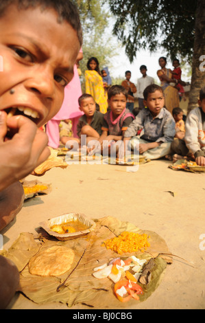 Young Indian village boy eating on the steps of his house. Andhra Stock ...