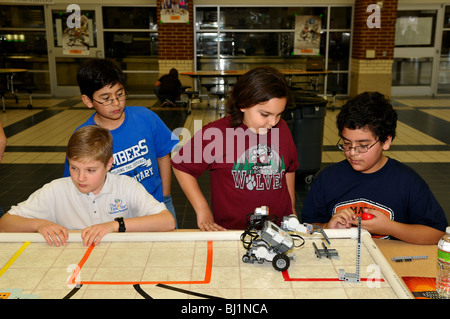 students group working on school project together on tablet computer at ...