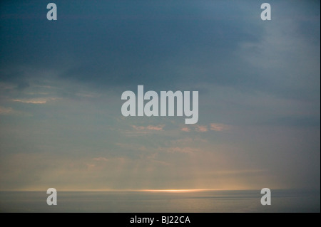 Sun with sunrays over ocean horizon. Sunrise, sunset seascape with ...