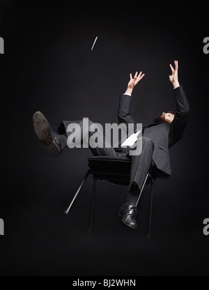 Man falling off a chair Stock Photo - Alamy