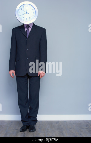 Man in suit with clock face Stock Photo - Alamy