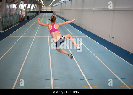 Teenage girl doing star jump on trampoline, outdoors Stock Photo - Alamy