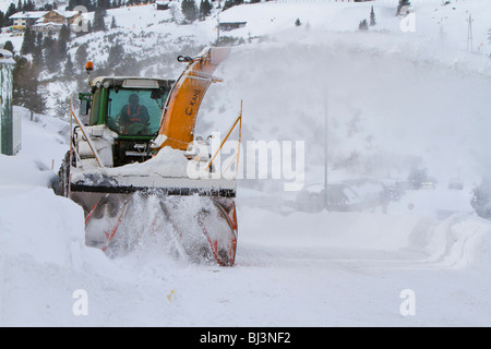 Tractor with snow thrower removing snow, Obertauern, Hohe Tauern region ...