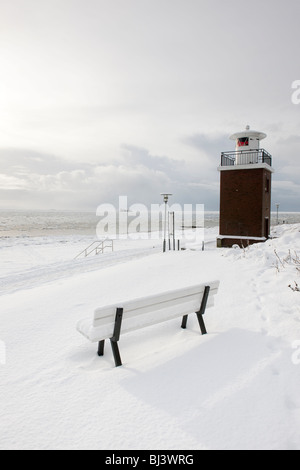 The Olhoern beacon on the snowy south beach of Wyk, North Sea island of ...