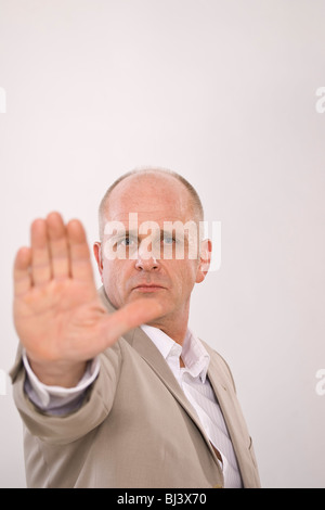 Man thrusting his hand forward in defense Stock Photo - Alamy