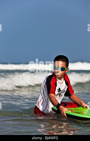 A boy boogie boarding while at the beach Stock Photo - Alamy