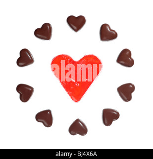 Heart-shaped plate with chocolate candies, bottle of wine and rose ...