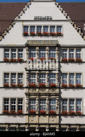 Front of the very traditional Hirmer Building with red flowerpots on ...