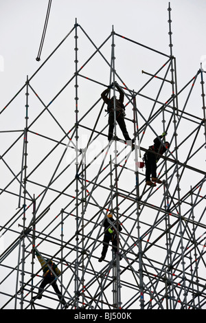 Construction Workers remove scaffolding from the clock face of ...