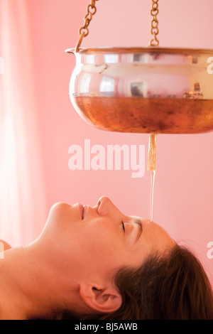 Woman enjoying a Ayurveda oil head massage treatment in spa Stock Photo ...