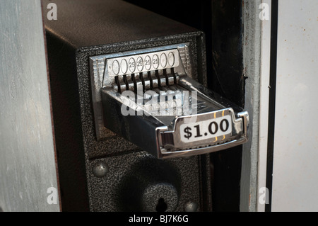 A quarter coin operating dispenser Stock Photo - Alamy