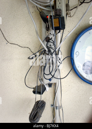A tangled mess of electrical wires creating a fire hazard Stock Photo ...