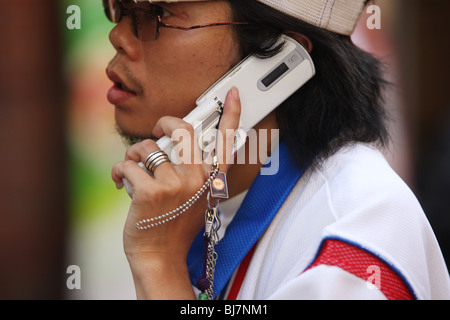 Japanese mobile telephone use by commuters and public in Tokyo, Japan ...
