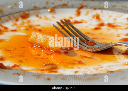 one last pasta quill on plate dish in sun at restaurant Stock Photo - Alamy