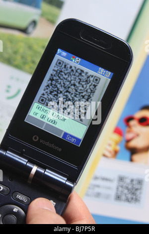 Using a mobile telephone to scan a 'QR Code' ( a square dot matrix ...