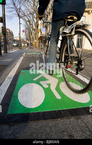 Cyclist cycles along a French bicycle / bike / cycle / lanes / lane in ...