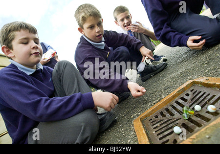 Traditional playground games being played on the school playground of a ...