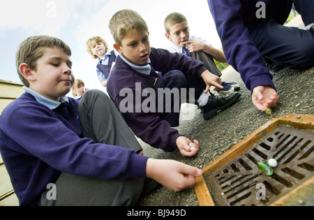 Traditional playground games being played on the school playground of a ...