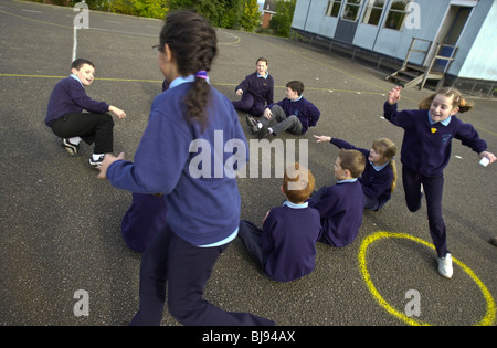 Traditional playground games being played on the school playground of a ...