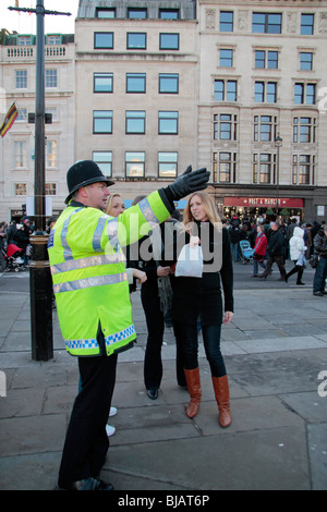 Female Police Officer Giving Directions to an Elderly Group of People ...