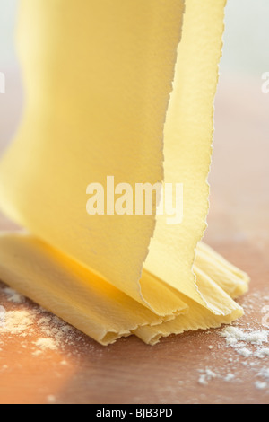 Fresh egg pasta drying hanging Stock Photo - Alamy