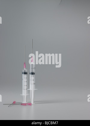 Syringe with needle standing upright Stock Photo - Alamy