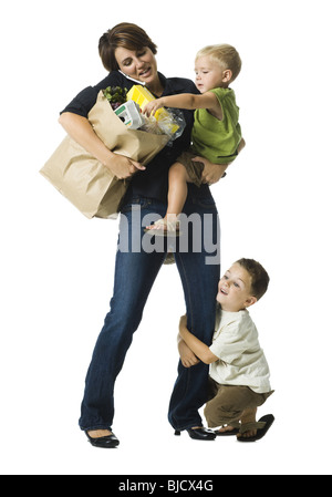 Busy Mom with baby and small child Stock Photo - Alamy