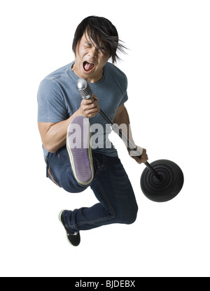 Man rocking out with mic stand Stock Photo - Alamy