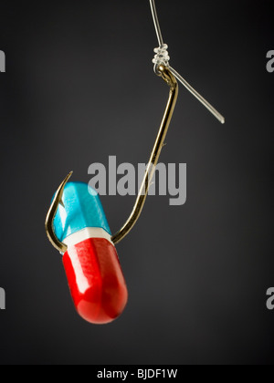 Pill on a fish hook Stock Photo - Alamy