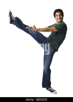 Studio portrait of young man dancing with maracas Stock Photo - Alamy