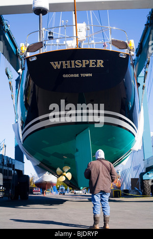 A travel lift operator controls a 300 tonne marine travel lift in ...