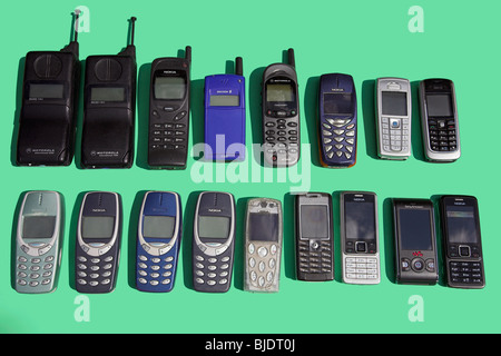 A Collection Of Old Mobile Cell Phones on A White Background Stock ...