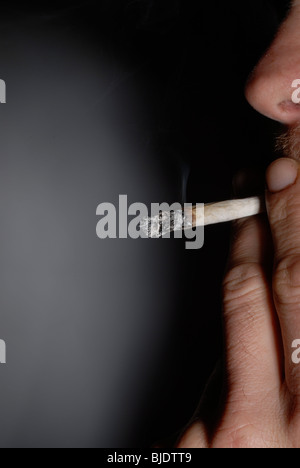 A cannabis spliff cigarette or joint being smoked, Amsterdam, Holland ...