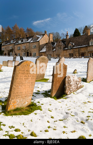 Snowshill village churchyard and cottages in the snow in December ...